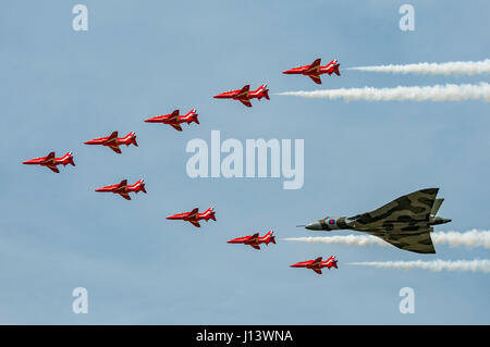 Avro Vulcan bomber and Red Arrows RAF BAe Hawk aircraft in formation at RIAT 2015, Fairford, UK ...