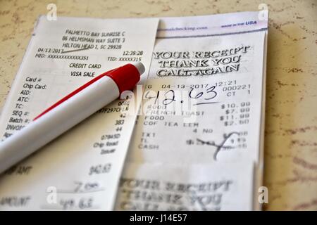 Restaurant tab receipt paid with tip included Stock Photo - Alamy