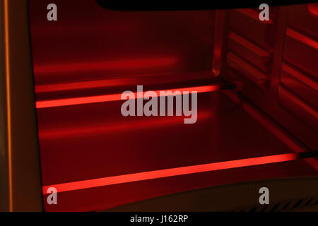 Glowing red, hot, electric range cooktop burner heating element coil ...