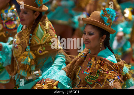 Morenada dancers in ornate costumes parade through the mining city of ...