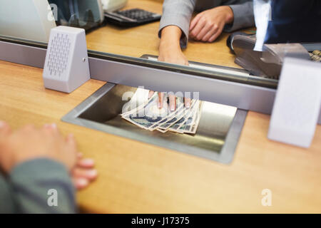 clerk giving cash money to customer at bank office Stock Photo - Alamy