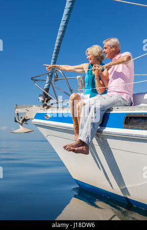 Woman pointing to the side on blue background Stock Photo - Alamy
