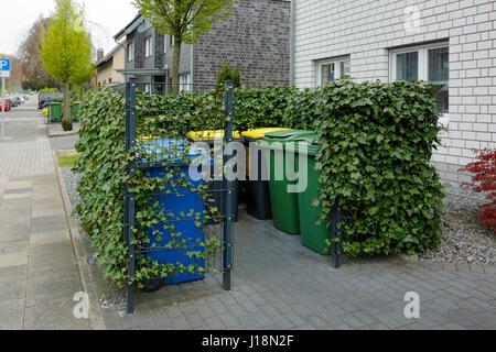 environment, dustbin in a collective deposit in front of a residential ...
