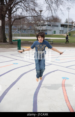 YOUNG BOY SKIPPING ROPE IN PARK Stock Photo: 138569614 - Alamy
