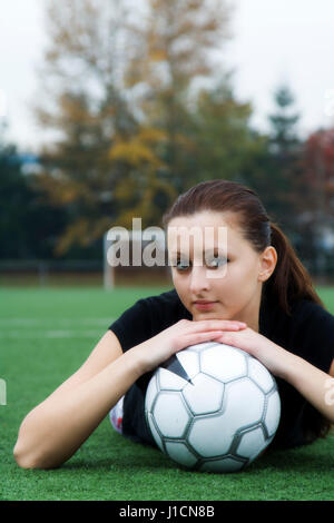 A beautiful soccer player resting on a soccer ball Stock Photo - Alamy