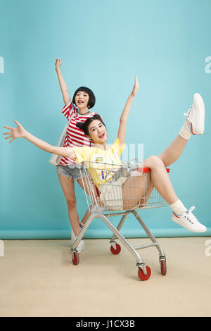 Portrait of two young sisters pushing each other on bed Stock Photo - Alamy