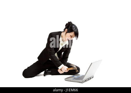 young business woman smashing a laptop. isolated on white Stock Photo ...