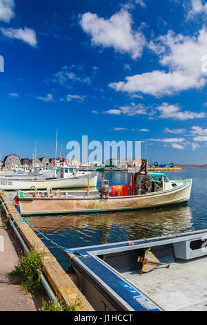 Fishing boats tied up at Malpeque Harbour wharf, Prince Edward Island ...