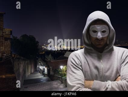 Digital composite of Anonymous Criminal in hood behind prison bars ...