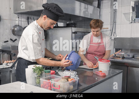 two people, chef assistant cooking food, commercial kitchen Stock Photo ...