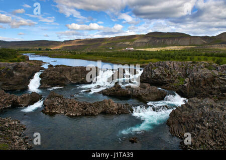Glanni Waterfall near Grabrokarhraun lava field and the small village ...