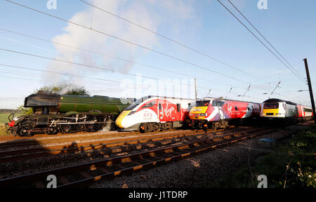EDITORIAL USE ONLY (left to right) The Flying Scotsman and Virgin Trains' new Azuma arrive at ...