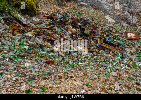 Rubbish tip, garbage, with broken glass, plastic and rusty metal ...