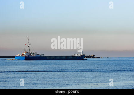 Blue cargo ship leaving Riga and entering Baltic sea Stock Photo - Alamy