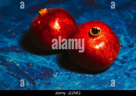 Whole red garnet on blue abstract backround Stock Photo - Alamy