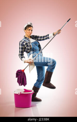 Beautiful woman with mop on pink background Stock Photo - Alamy