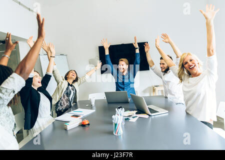 Happy colleagues are cheering after successfully completing task Stock ...