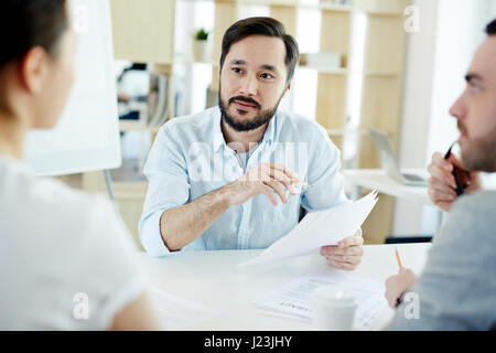 Listening intently. a group of business colleagues having a strategy ...