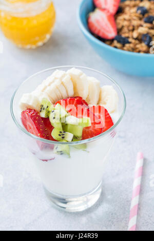 Fruit salad with natural yogurt in glass bowl isolated on white ...