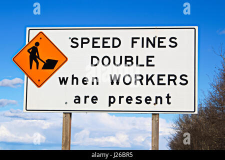 Speed fines double sign along highway Stock Photo - Alamy