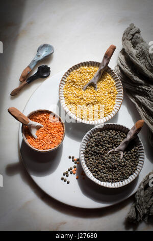 Spoons with healthy lentils on grey background Stock Photo - Alamy
