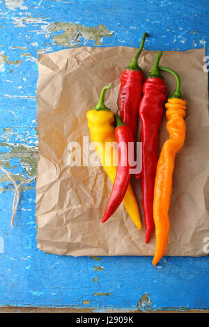Green and red spicy papper on wooden background in studio photo. Fresh ...