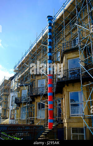 Builders scaffolding waste chute Stock Photo - Alamy