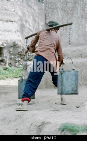 china, man carrying buckets Stock Photo - Alamy