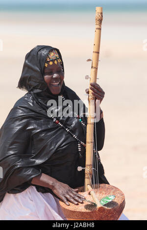 Africa, Western Sahara, Dakhla. Woman in tradition dress performing a ...
