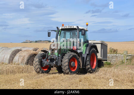 a green fendt tractor with red wheels at a field at a historic farm ...
