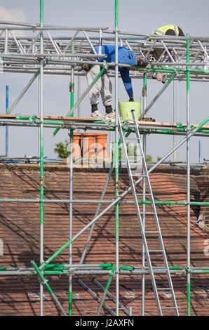Scaffolding canopy being erected over domestic house roof in London ...