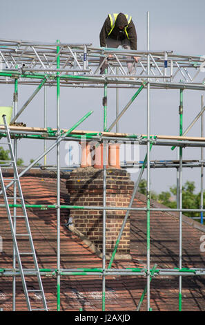 Building work and scaffolding being erected by scaffolders around Stock ...