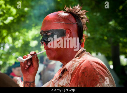 Native American of the Northeast Tribes smokes a pipe during the Fort ...