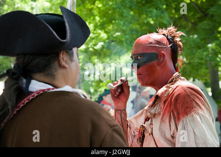 Native American of the Northeast Tribes smokes a pipe during the Fort ...