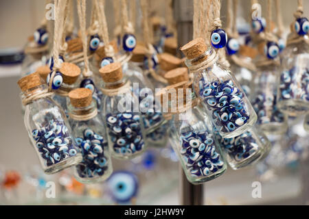 Little transparent glass bottle filled with blue evil eye beads Stock ...
