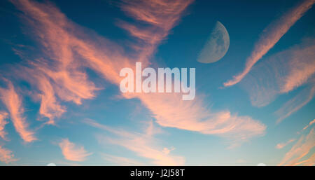 sunset half moon pink clouds. moon rising Stock Photo - Alamy