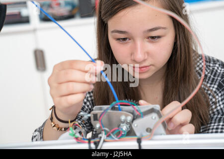Student girl in electronics laboratory, experiment with microcontroller ...