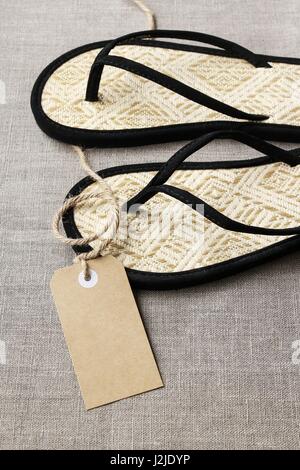 Flip flops with price tag, copy space Stock Photo - Alamy