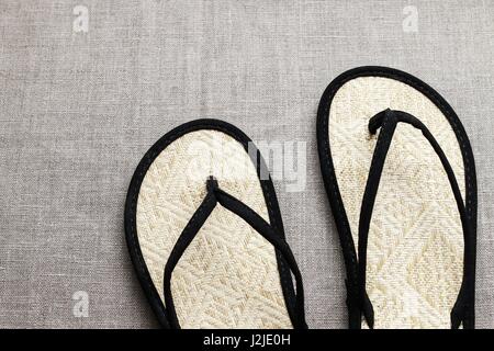 Flip flops on linen background, copy space Stock Photo - Alamy