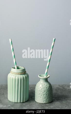 Ceramic jars and stripped straws. Party time Stock Photo - Alamy
