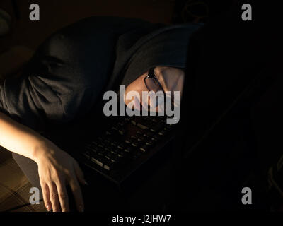 Hacker girl is sleeping beside the laptop Stock Photo - Alamy