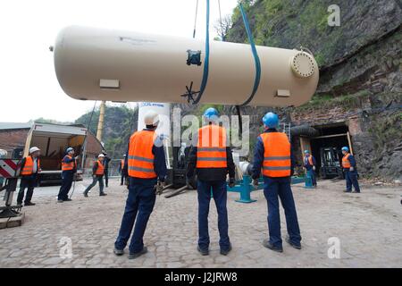 An eight-meter-long and ten-ton particle accelerator tank hanging from ...
