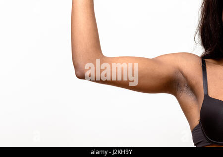 Underarm view of a muscular young African woman raising her arm and ...