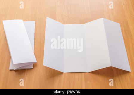 Four - fold white template paper on black background Stock Photo - Alamy