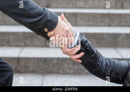 Close up of senior man helping son choose bow tie in store. Concept of ...