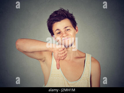 Skeptical and displeased man showing thumbs down, wearing winter ...