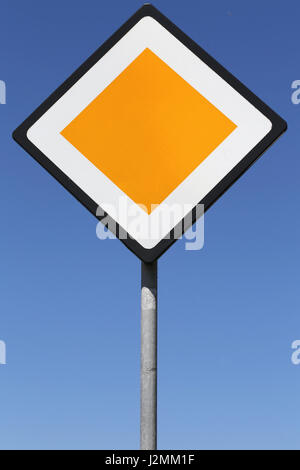 Priority road traffic sign on a pole in Germany. Main street symbol in ...