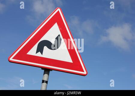 Double bend first to right road sign in Britain Stock Photo - Alamy