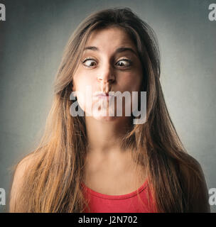Beautiful woman making a silly face with hands on the eyes, isolated ...