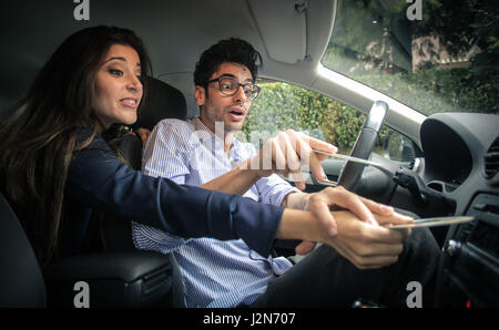 Confused young woman driving car against background of angry screaming ...